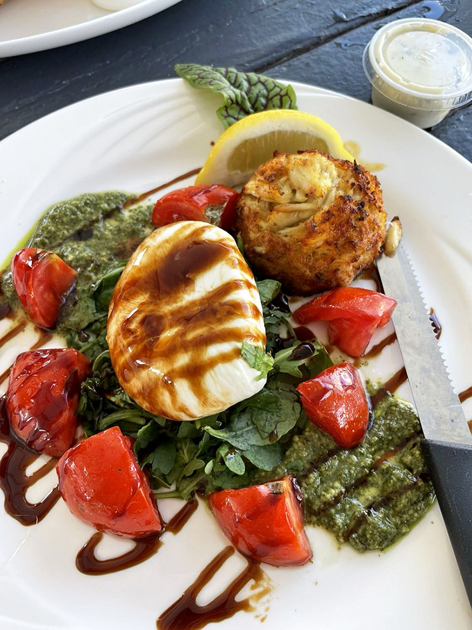 A perfectly bronzed crab cake perches beside grilled mozzarella like the sun and moon of Maryland's culinary universe.