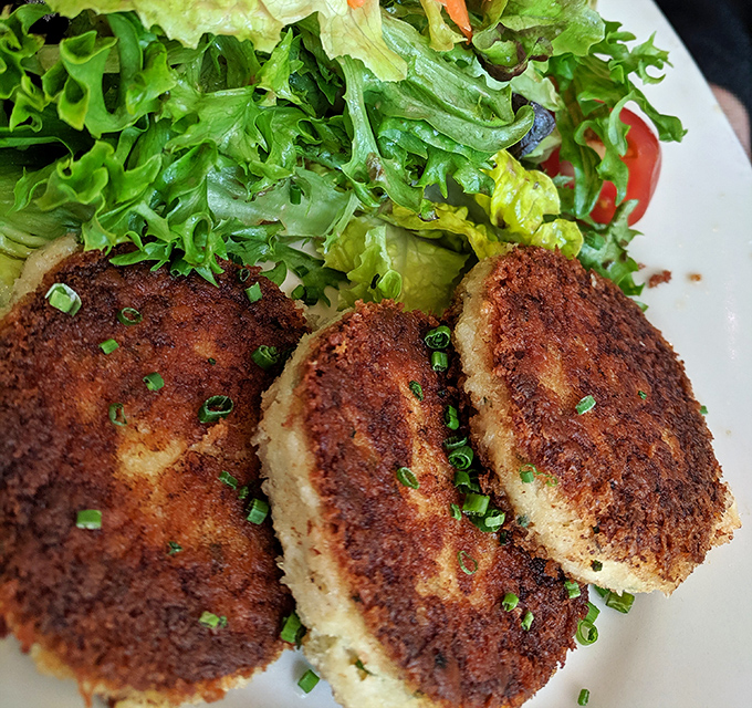 Golden-brown perfection! These crab cakes achieve that mythical balance&mdash;crispy exterior giving way to sweet, tender Dungeness crab that makes you momentarily forget your table manners.