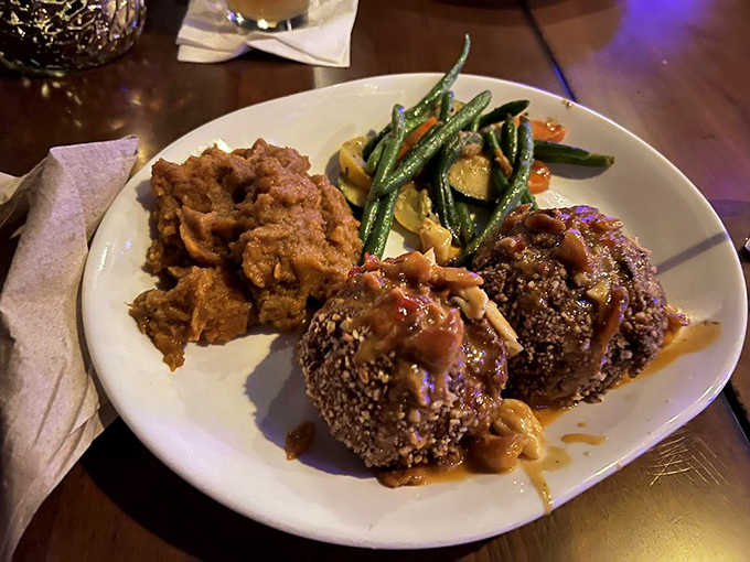 Sesame-crusted perfection meets savory sauce in a dish that would make Neptune himself swim upstream. These crab cakes don't just speak&mdash;they sing.