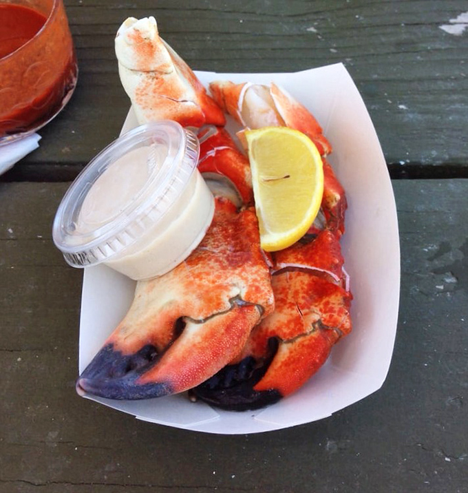 Nature's perfect finger food: sweet stone crab claws with a side of sunshine. The bright lemon wedge isn't just garnish&mdash;it's the perfect dance partner.