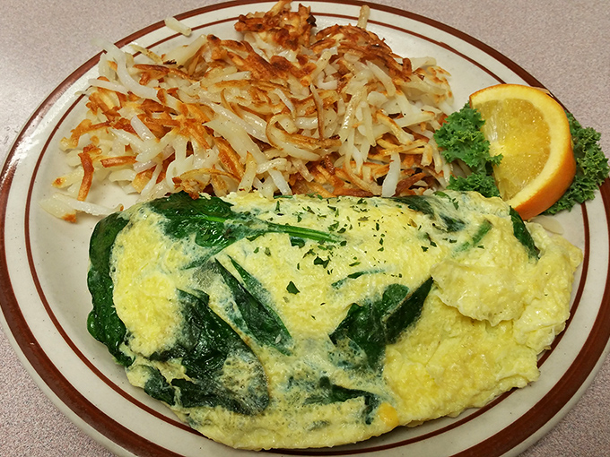 This crab omelet doesn't just flirt with perfection, it's in a committed relationship&mdash;golden eggs embrace vibrant greens while hash browns stand crispy guard.