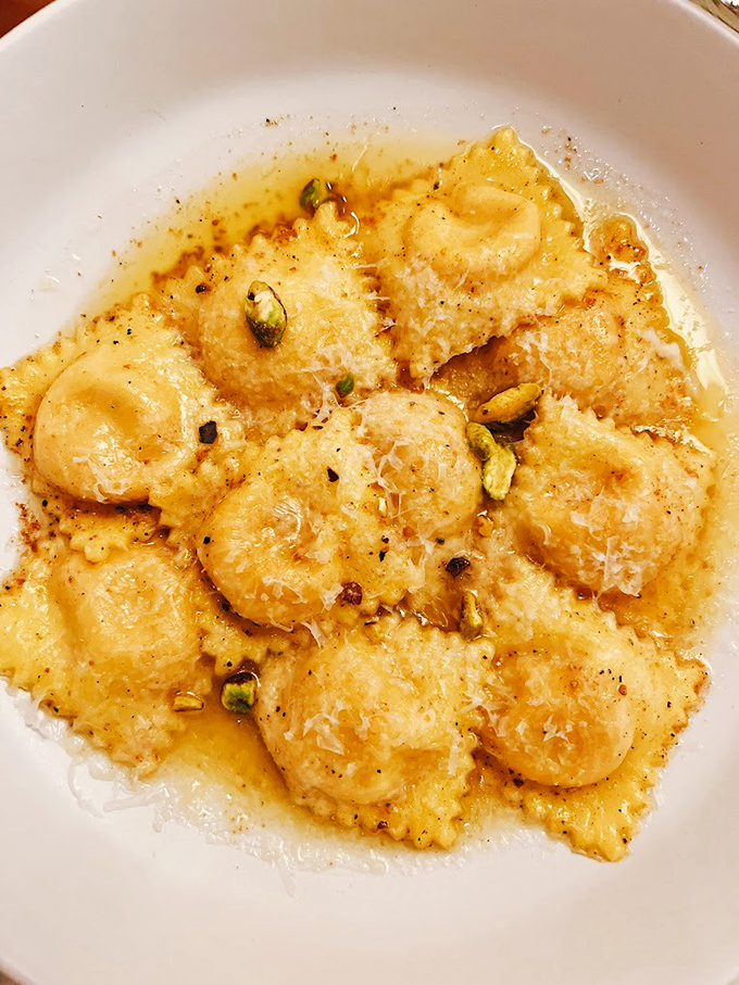 These golden pillows of crab ravioli aren't just pasta &ndash; they're edible poetry, glistening in a sauce that deserves its own sonnet.