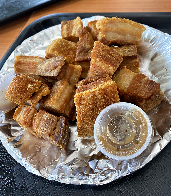 Crispy pork belly that shatters like glass then melts like butter. The accompanying dipping sauce cuts through the richness with perfect precision.