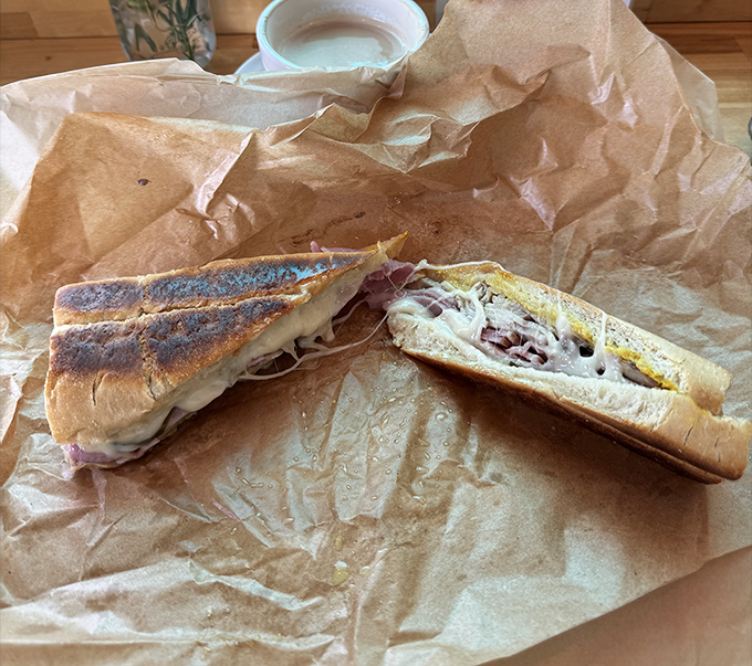 Behold the star of the show: perfectly pressed Cuban bread revealing layers of pork, ham, and cheese that'll make you want to slow-clap.
