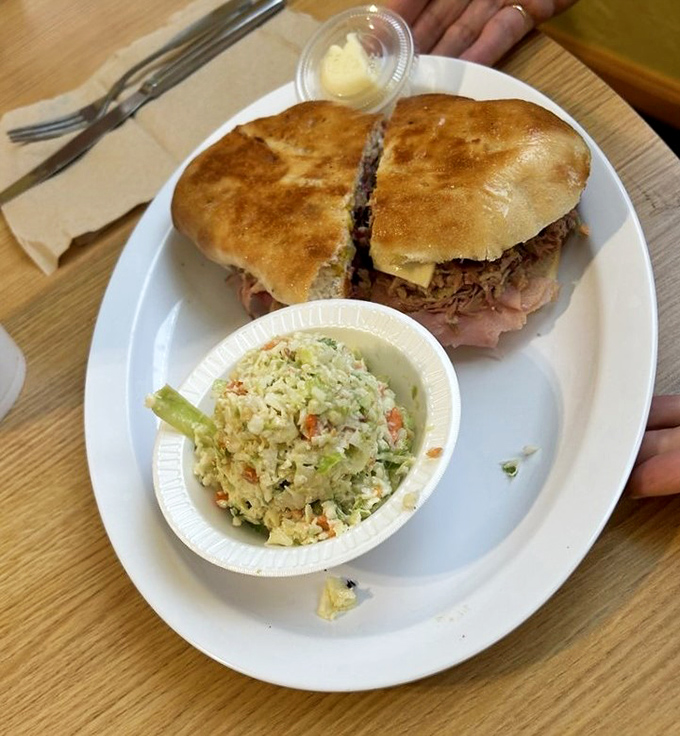 This Cuban sandwich doesn't just satisfy hunger – it resolves existential crises. The perfect press marks are like sandwich credentials.