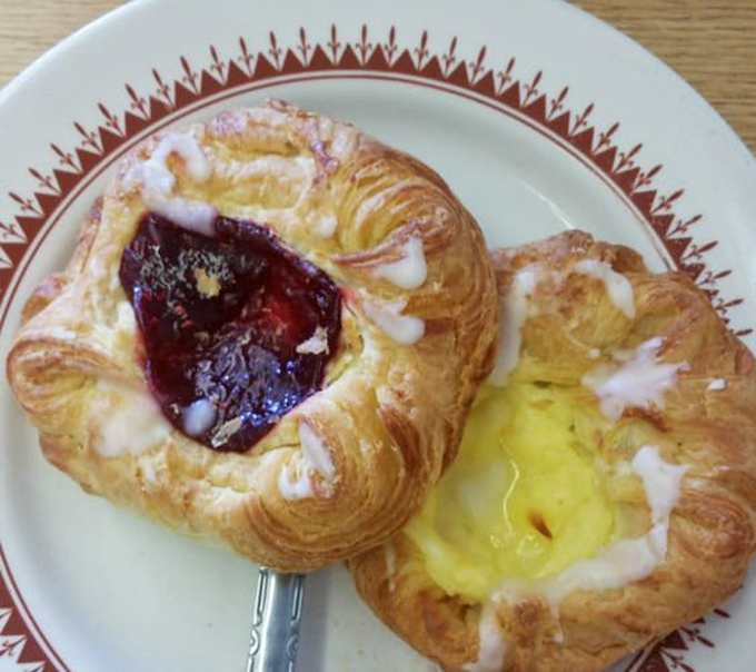 These Danish pastries aren't just breakfast, they're an edible art form &ndash; flaky spirals cradling jewel-toned raspberry and sunny custard centers.