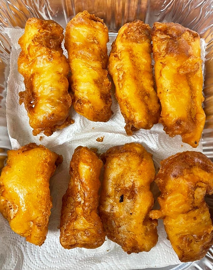 Golden-battered cod that makes the perfect sound when your fork breaks through—that satisfying crunch that says, "This is going to be worth every calorie."