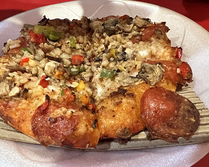 Behold the legendary Deluxe Pizza in all its glory – where pepperoni, sausage, and veggies unite in perfect harmony on that signature thin crust.