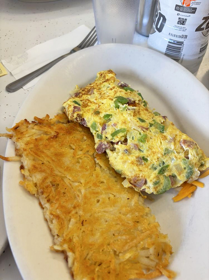 This Denver omelet isn't trying to reinvent breakfast &ndash; it's perfecting it. Golden eggs embrace ham and peppers while those hash browns deserve their own fan club.