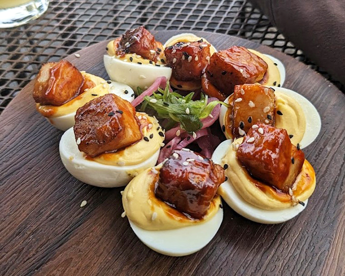 These aren't your aunt's potluck deviled eggs. Each one crowned with glazed pork belly, they're the kind of appetizer that ruins family reunions forever.