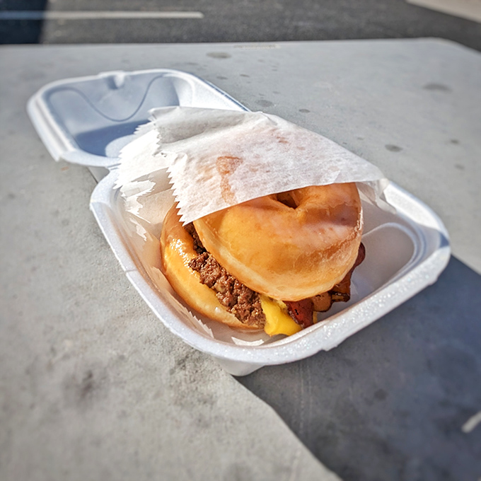 This burger doesn't just sit in its container – it lounges, confident in its ability to make you forget every diet promise you've ever made.