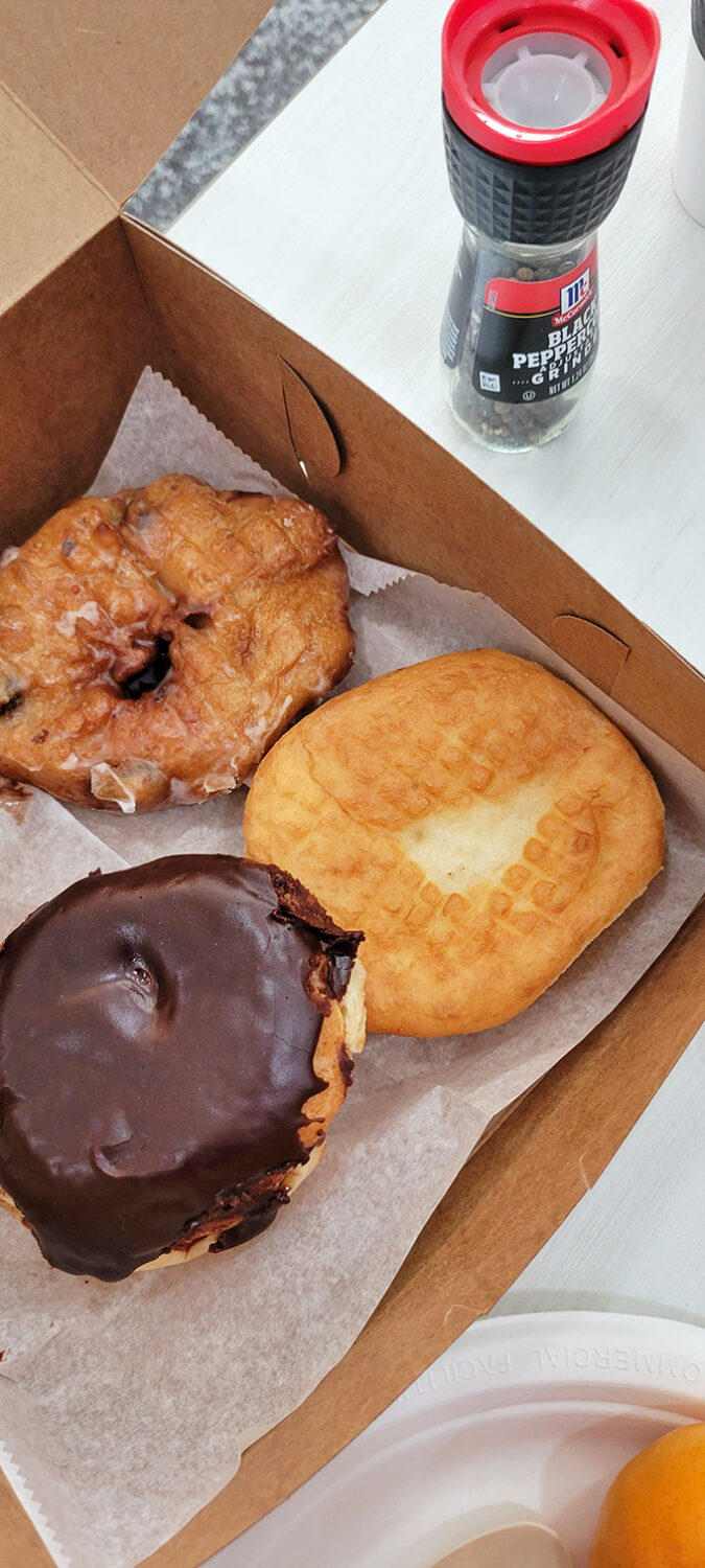 The holy trinity of donut perfection: glazed, chocolate-dipped, and apple fritter. Add coffee and you've basically achieved nirvana in a cardboard box.