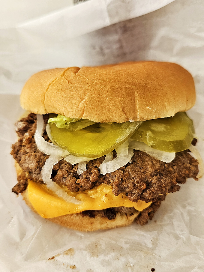 This isn't just a burger; it's edible nostalgia. Crisp-edged patty, melty American cheese, and those perfect pickle chips&mdash;a masterclass in simplicity.