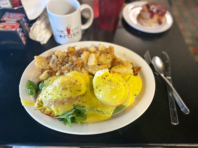 Eggs Benedict perfection: golden hollandaise cascading over perfectly poached eggs with home fries standing by for the encore performance.