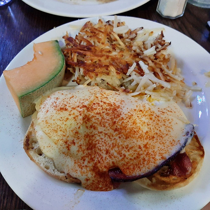 This isn't just breakfast&mdash;it's edible architecture. Perfectly poached eggs with crispy hash browns and fresh cantaloupe create the ideal morning trilogy.