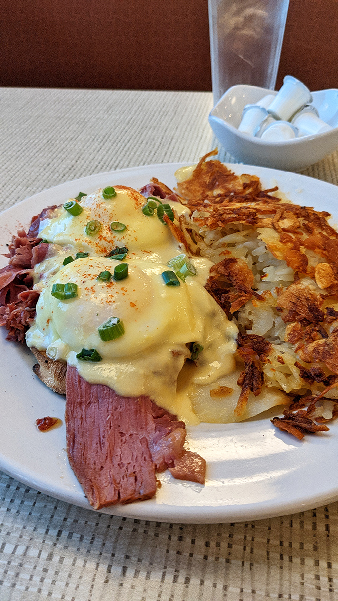 Behold the star attraction: Eggs Benedict with perfectly poached eggs cascading golden yolk onto Canadian bacon, all swimming in hollandaise that deserves its own fan club.
