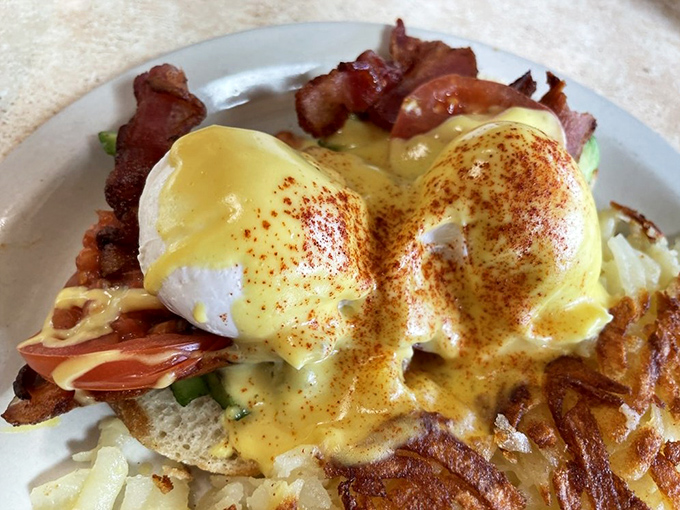 Behold the holy grail of breakfast&mdash;eggs benedict with perfectly poached eggs where the yolks cascade like liquid sunshine over crispy bacon and English muffins.