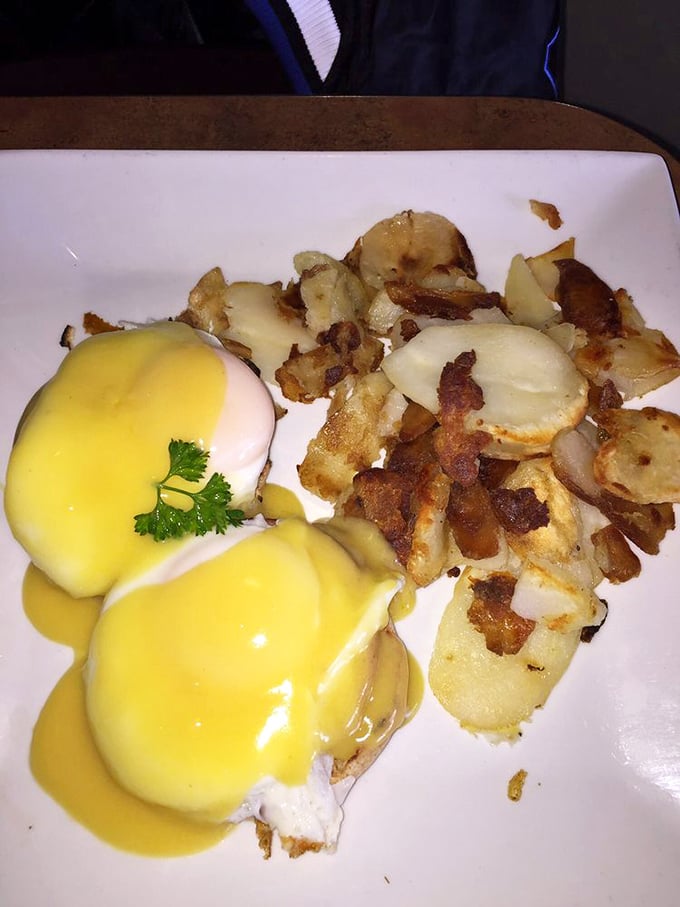 Behold the holy trinity of breakfast perfection: golden hollandaise cascading over poached eggs with home fries that actually taste like potatoes, not afterthoughts.