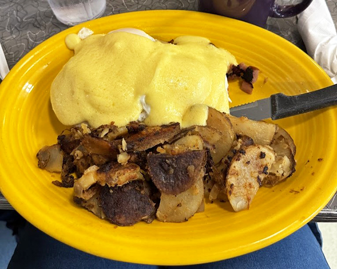 Behold the star of our show: eggs Benedict with home fries that could make a potato farmer weep with pride. That hollandaise sauce looks like liquid sunshine.