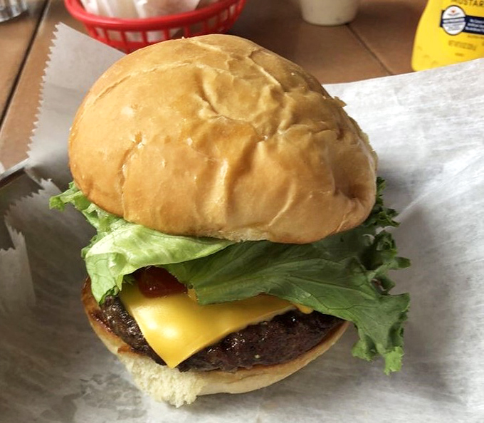 This isn't just a burger&mdash;it's edible architecture. Notice how the melted cheese creates the perfect foundation for that garden-fresh lettuce.