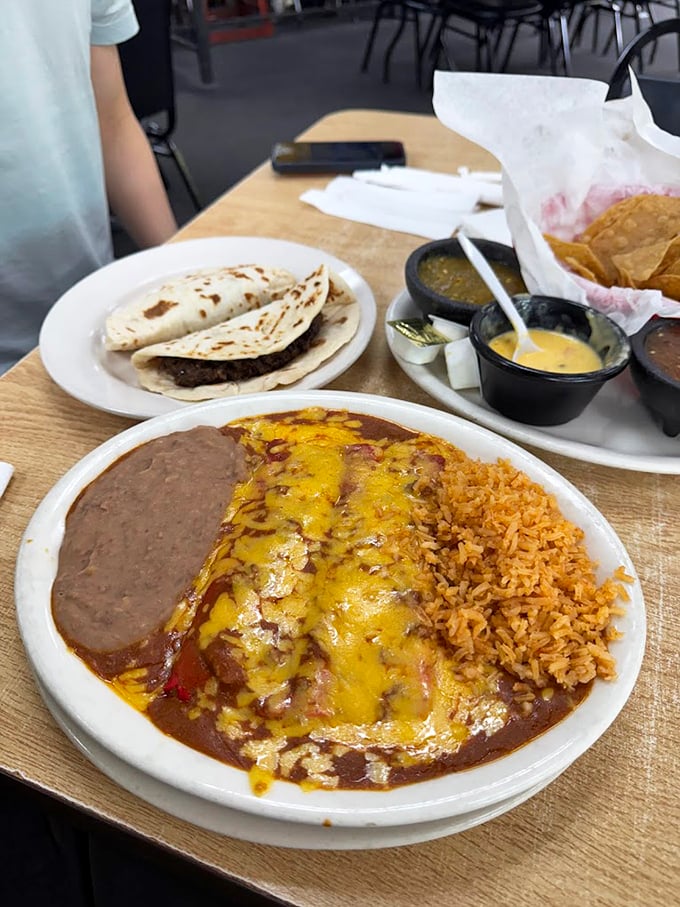 Behold the star attraction: cheese enchiladas swimming in that legendary chili gravy, with perfectly executed rice and beans standing by for support.