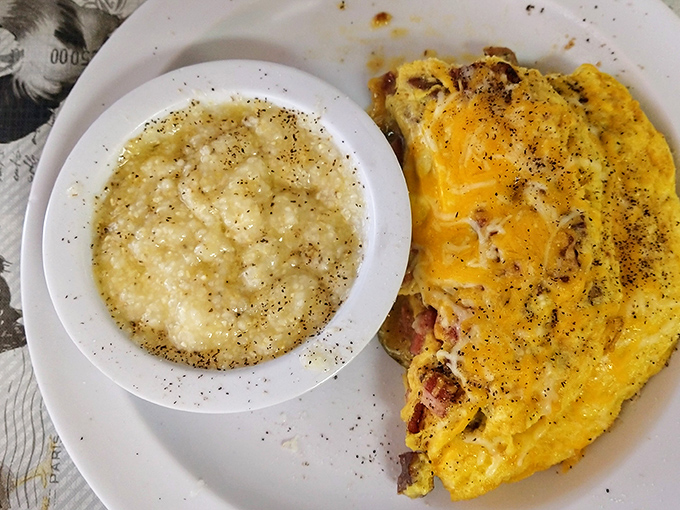 The farmer's omelet arrives looking like a golden pillow stuffed with garden-fresh dreams and crispy potatoes.