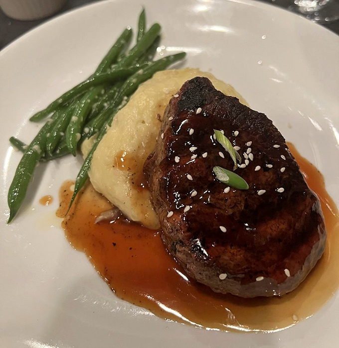 Behold the star of the show: a filet mignon so perfectly seared it makes you wonder if the chef has some sort of pact with the culinary gods.