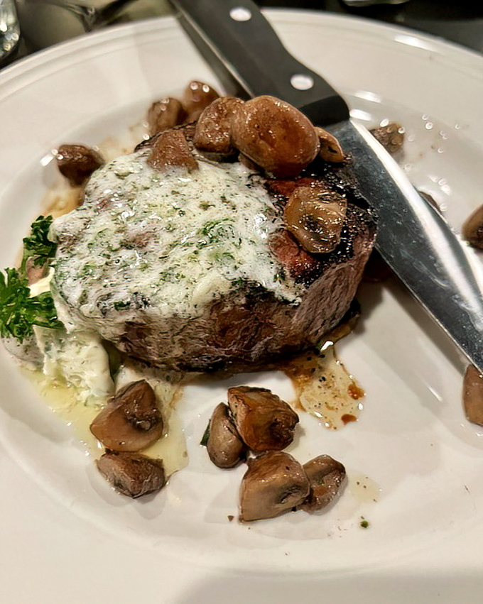 Not all heroes wear capes; some come topped with herb butter and mushrooms on a white plate that's about to make your evening legendary.