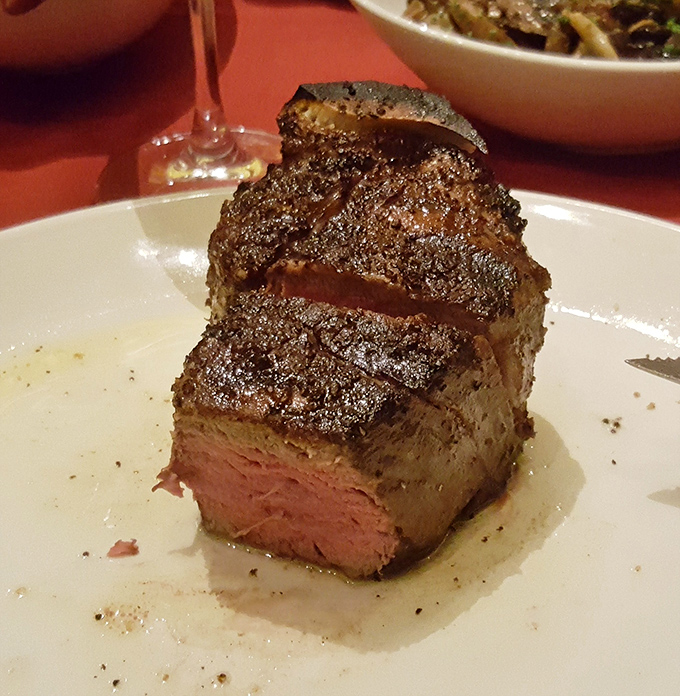 Behold the star of the show: a perfectly seared filet mignon with that textbook medium-rare center. This isn't just dinner; it's performance art.