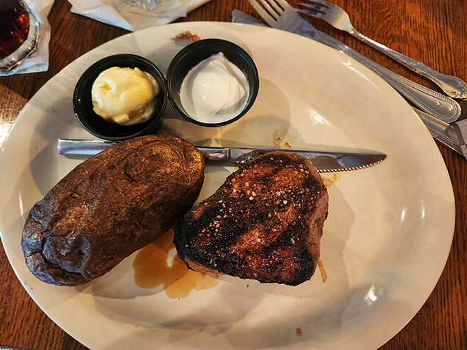 This isn't just a filet mignon&mdash;it's a masterclass in simplicity. Perfectly seared exterior, tender interior, and a baked potato standing by for support.
