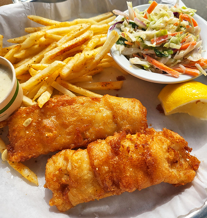 Golden-battered fish that shatters with each bite, paired with fries that could make a Frenchman weep with joy.