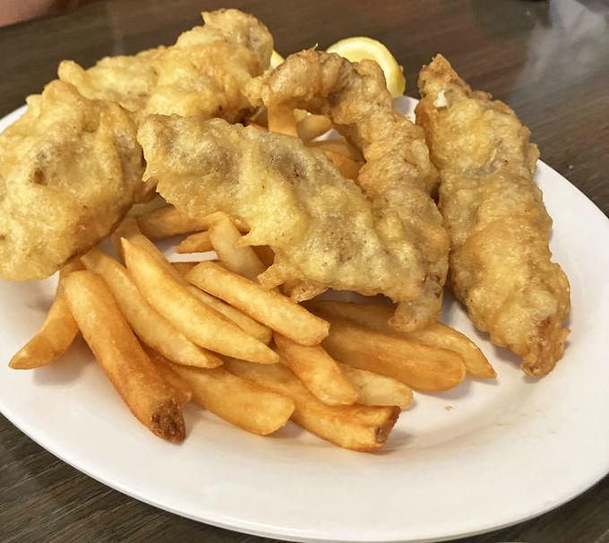 Golden batter that crackles like autumn leaves, revealing tender fish that'll ruin you for frozen alternatives.