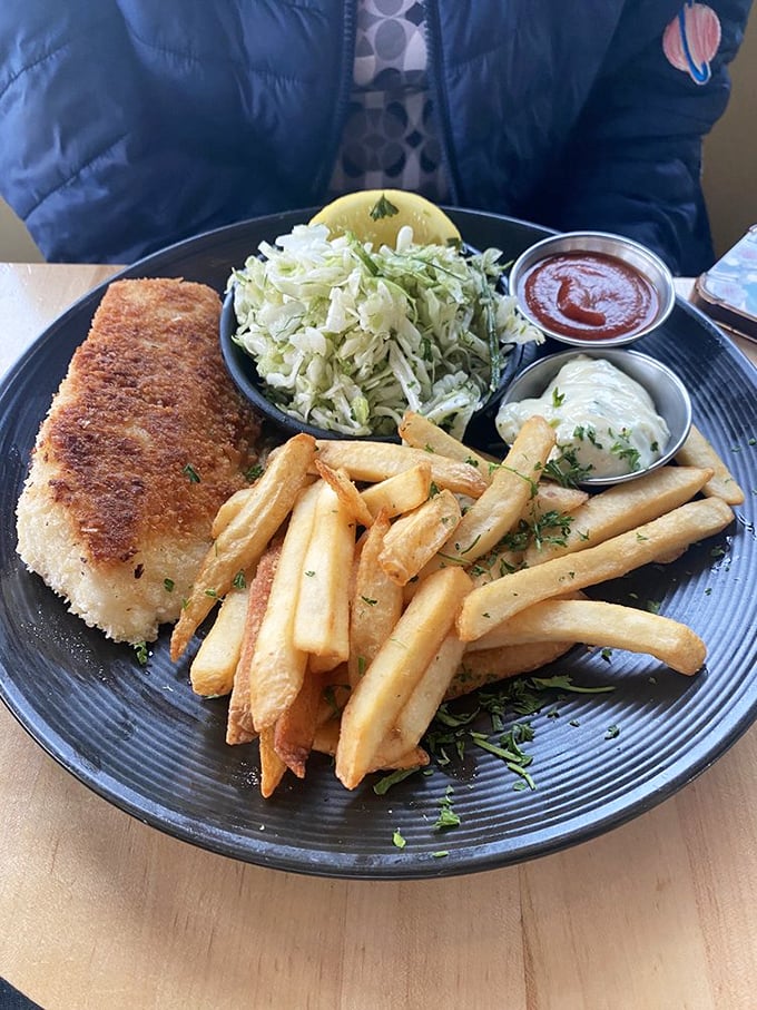 This isn't just fish and chips&mdash;it's a masterclass in texture. The golden-brown armor shatters to reveal pearly white fish that would make Neptune himself weep with joy.