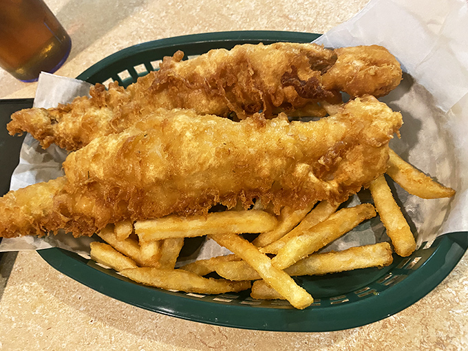 Golden-battered fish fillets perched atop a bed of crispy fries&mdash;this isn't just fish and chips, it's edible sunshine that crunches.