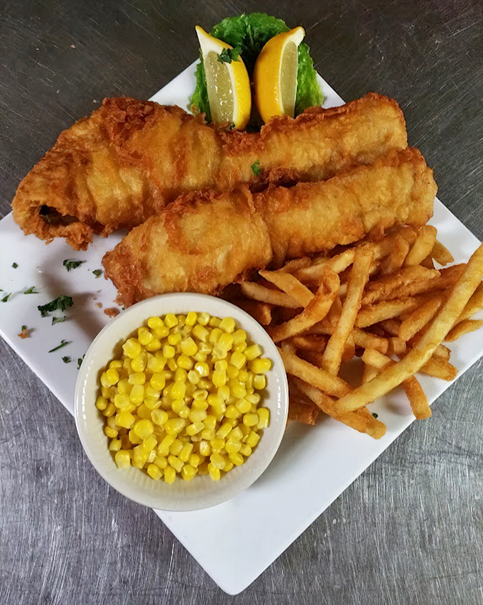 Golden-battered fish that shatters with each bite, served alongside crispy fries and sweet corn. This isn't just food&mdash;it's edible sunshine on a plate.