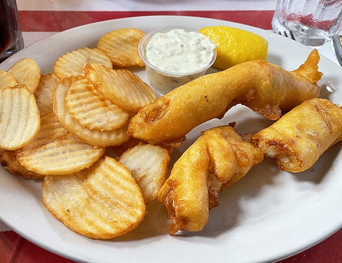Golden perfection arrives: crispy fish that would make British grandmothers weep tears of joy.
