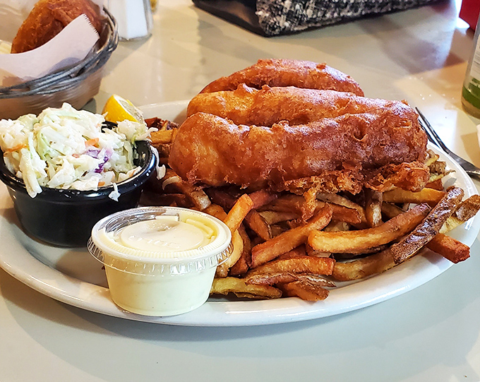 Golden-battered fish that shatters with each bite, revealing pearly white flesh beneath. This isn't just fish and chips&mdash;it's edible architecture.