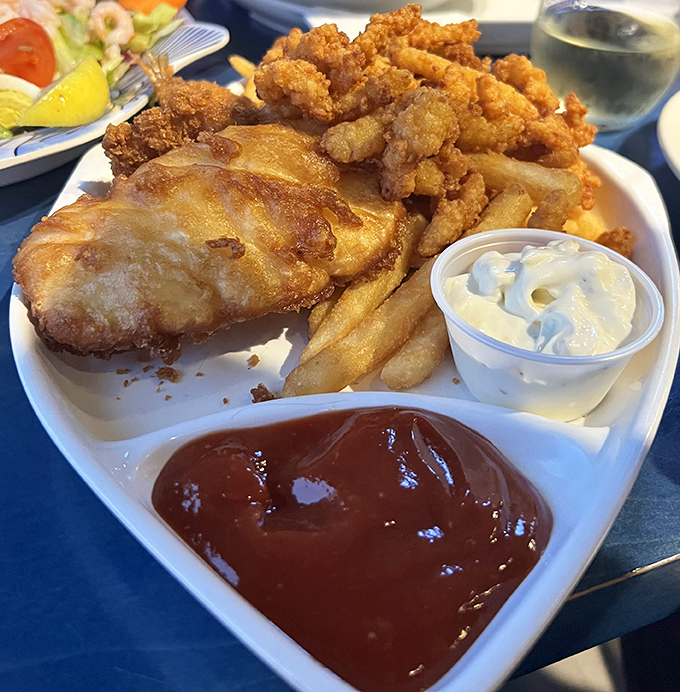 Golden-battered fish and chips that shatter with each bite, served with the kind of fries that make sharing a moral dilemma.