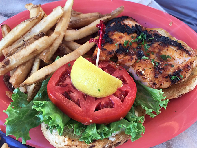 The star of the show: a blackened fish sandwich that makes snowbirds extend their Florida stays. That perfect char speaks volumes about Keegan's grill mastery. 