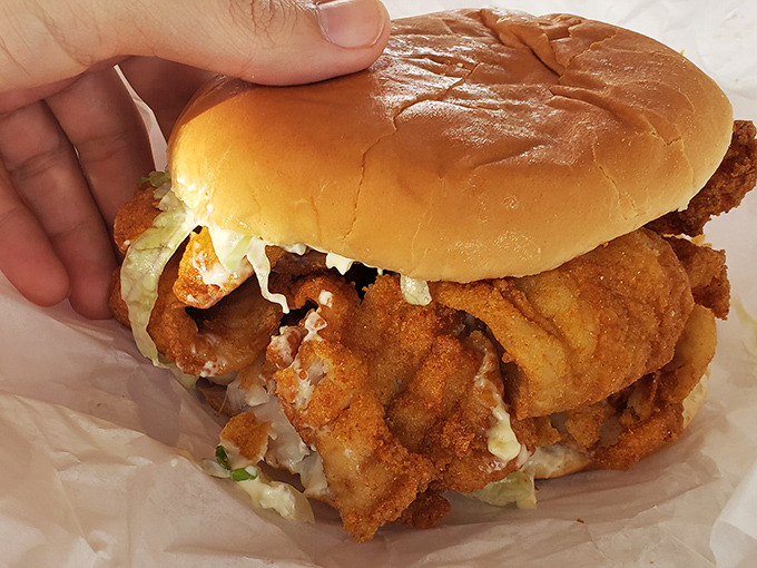 Behold the star attraction: golden-fried fish spilling beyond its bun boundaries. This sandwich doesn't just satisfy hunger&mdash;it creates food memories that last for years.