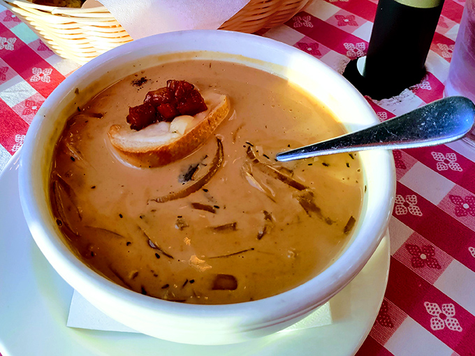 This French onion soup isn't messing around. A golden crown of melted cheese protecting a rich broth that's been simmering long enough to tell stories.