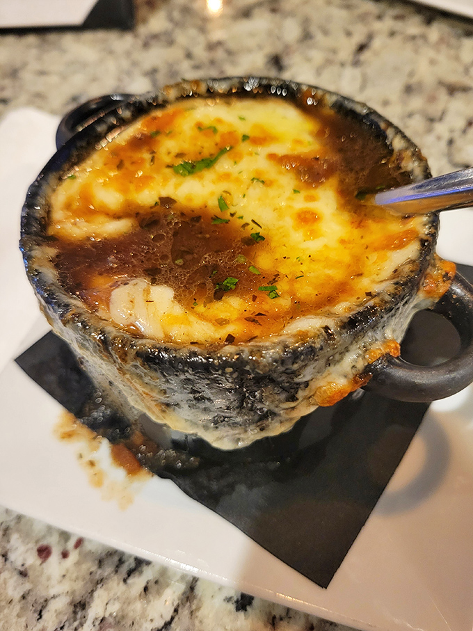 This isn't just French onion soup&mdash;it's a bubbling cauldron of cheese-capped bliss that demands a moment of reverent silence before diving in.