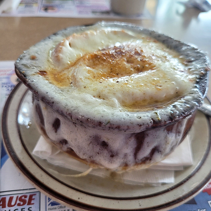 This French onion soup isn't just topped with cheese &ndash; it's wearing a magnificent crown that would make Louis XIV weep with envy.