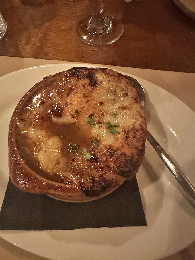 Behold the crown jewel: French onion soup with a bronzed cheese cap that stretches dramatically with each spoonful.