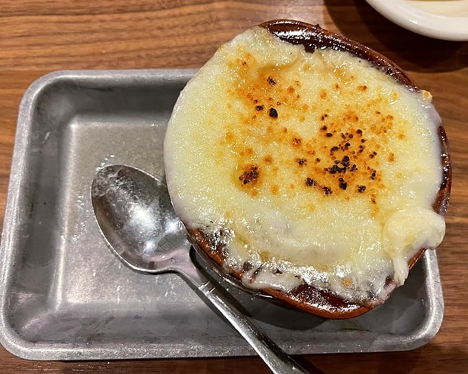 This isn't just French onion soup&mdash;it's a religious experience in a crock, with a cheese canopy that stretches skyward like the dreams of hungry diners.