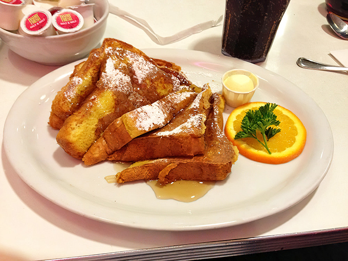Golden-brown French toast that's crisp outside, custardy inside, with a snowfall of powdered sugar. Breakfast nirvana exists, and it comes with a side of nostalgia.