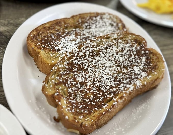 Behold the star attraction: French toast dusted with powdered sugar like the first perfect snowfall of winter. Worth every calorie.