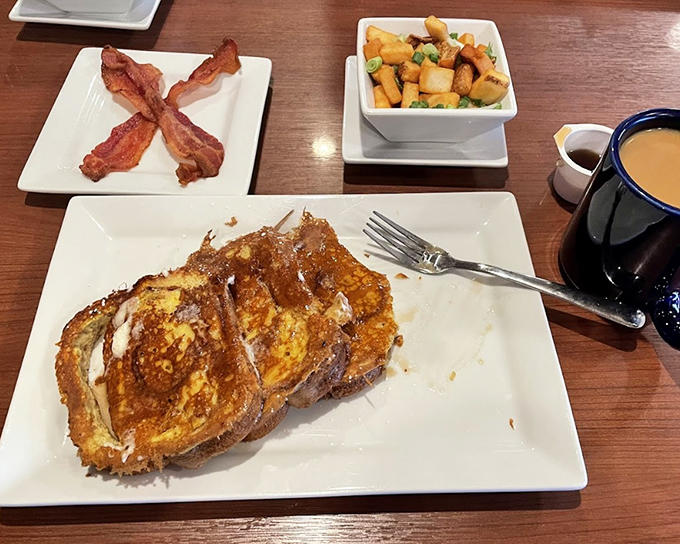 This French toast isn't just breakfast, it's an event&mdash;golden-brown perfection flanked by crispy bacon and home fries that demand attention.