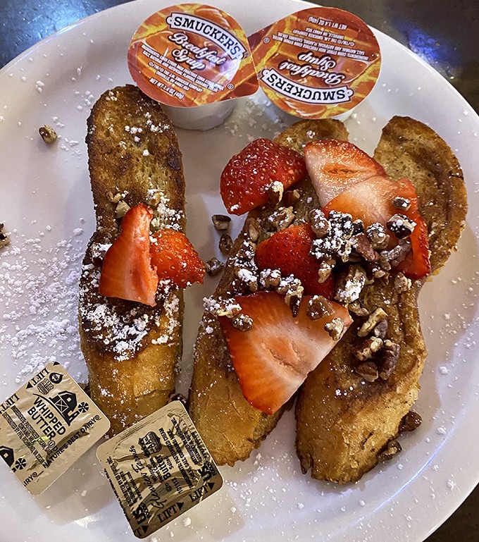 This isn't just French toast &ndash; it's a breakfast masterpiece with fresh strawberries and a dusting of powdered sugar that would make Michelangelo weep.