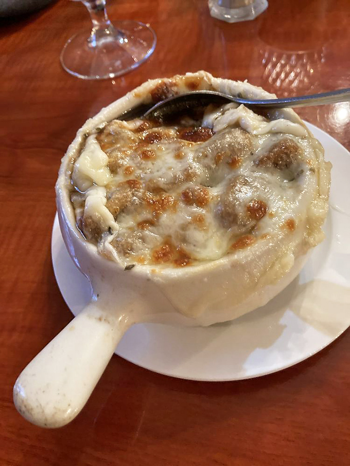 French onion soup that's worth the cheese pull! This bubbling cauldron of comfort comes with enough melted provolone to make your cardiologist wince.